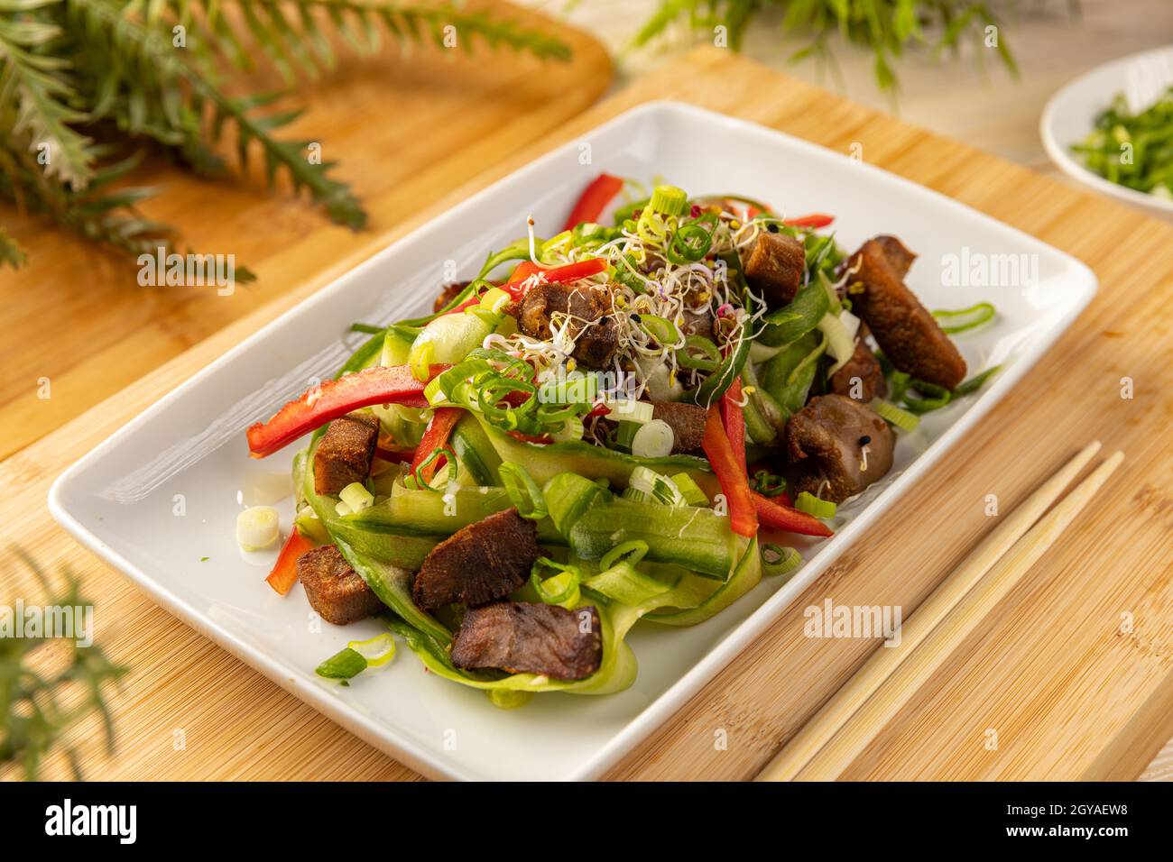 Asian style salad with beef cubes decorated with sprouts Stock Photo ...