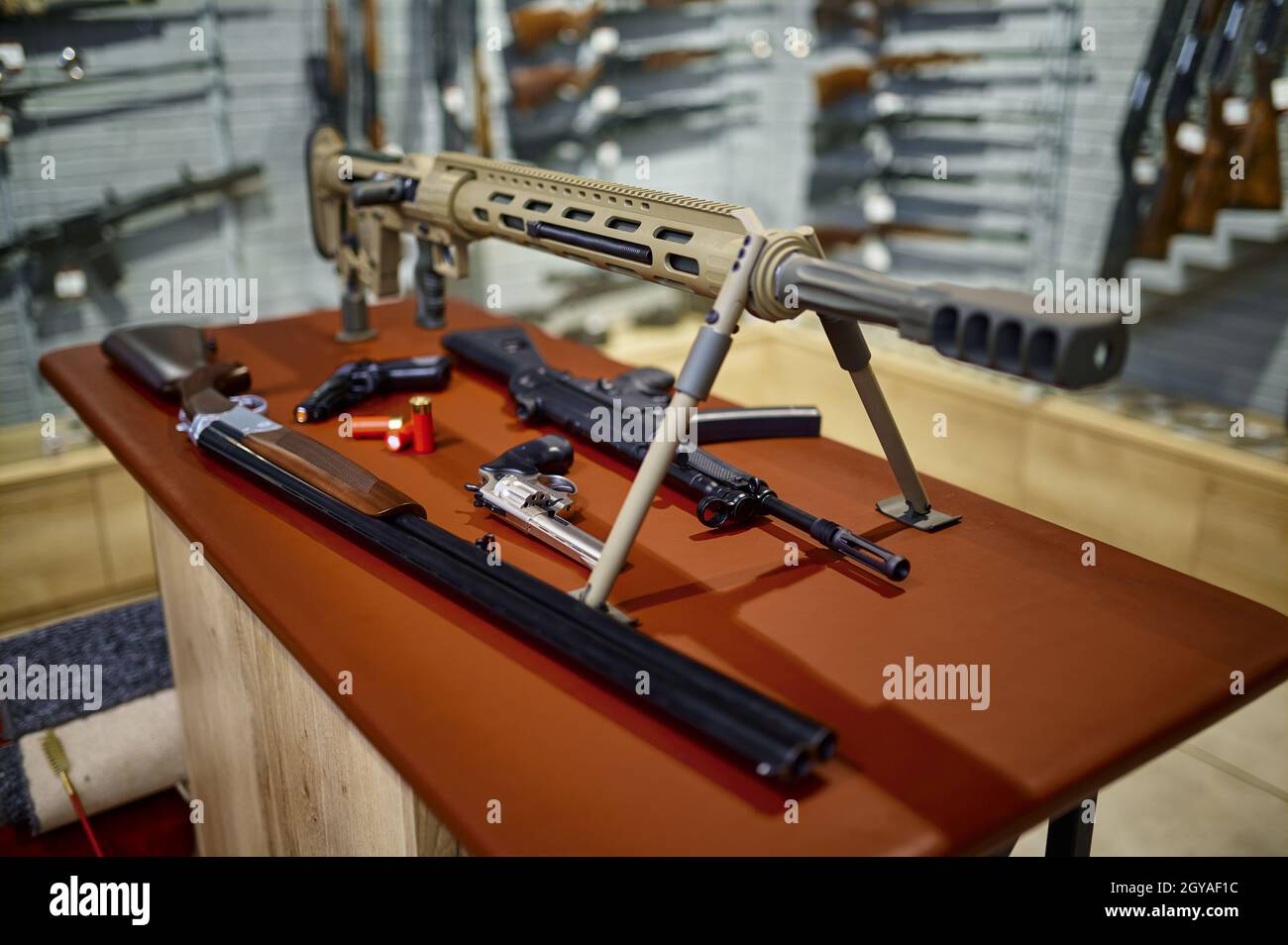 Rifles and pistols on counter in gun store closeup, nobody. Weapon shop ...