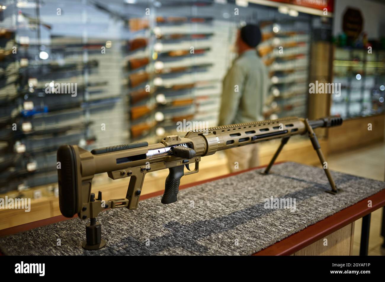 Powerful rifle on counter in gun store closeup, nobody. Weapon shop ...
