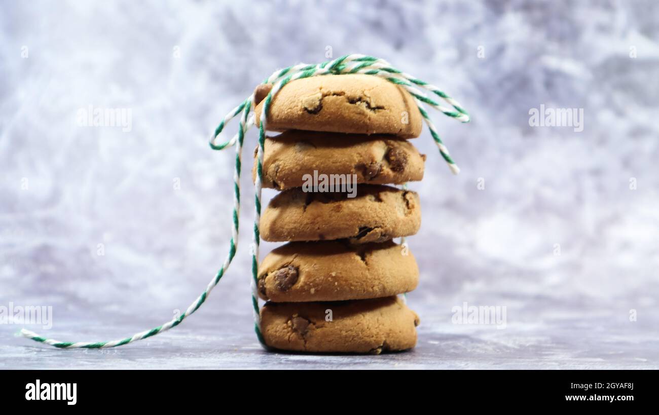 American chocolate chip cookies stacked on top of each other with green ...