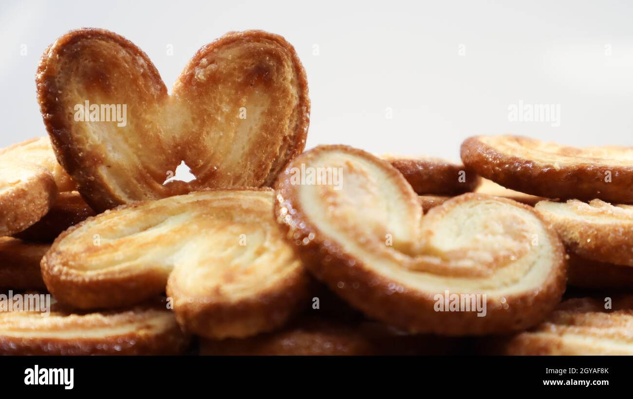 Fresh puff pastry palm cookies in the shape of a heart. Classic French ...