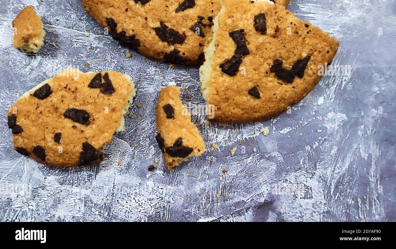 One soft freshly baked chocolate chip cookie with crumbs and chunks on ...