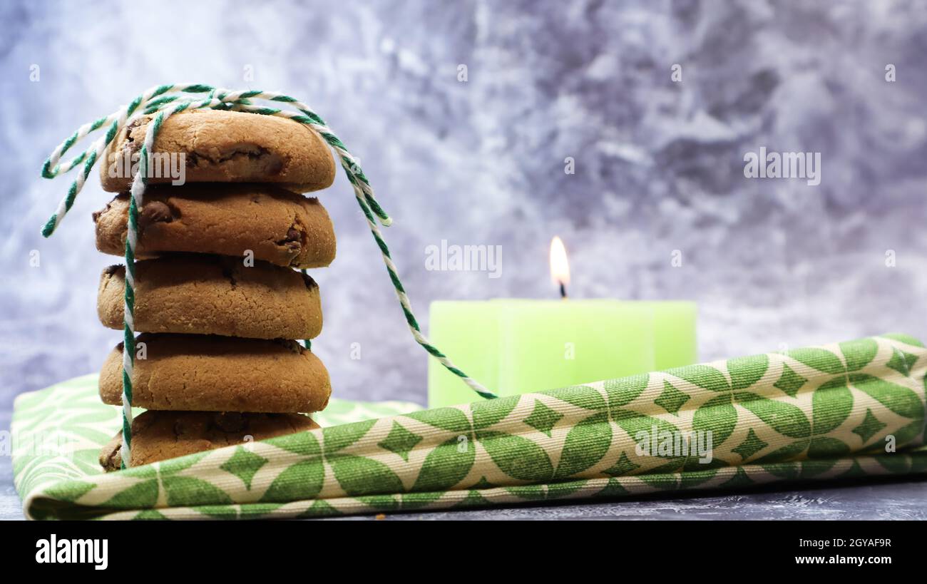 American chocolate chip cookies in a stack tied with thread on a green ...