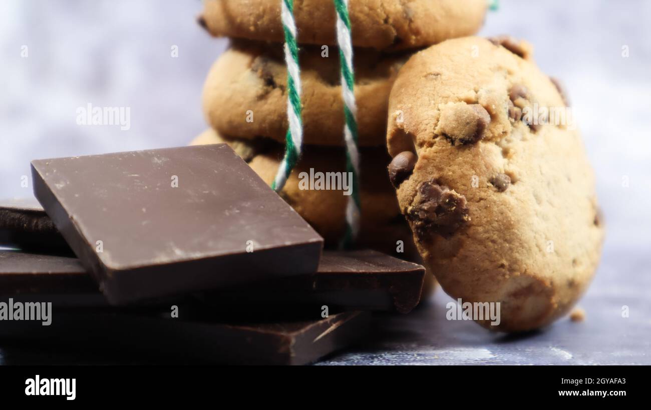 American chocolate chip cookies stacked on top of each other with green ...