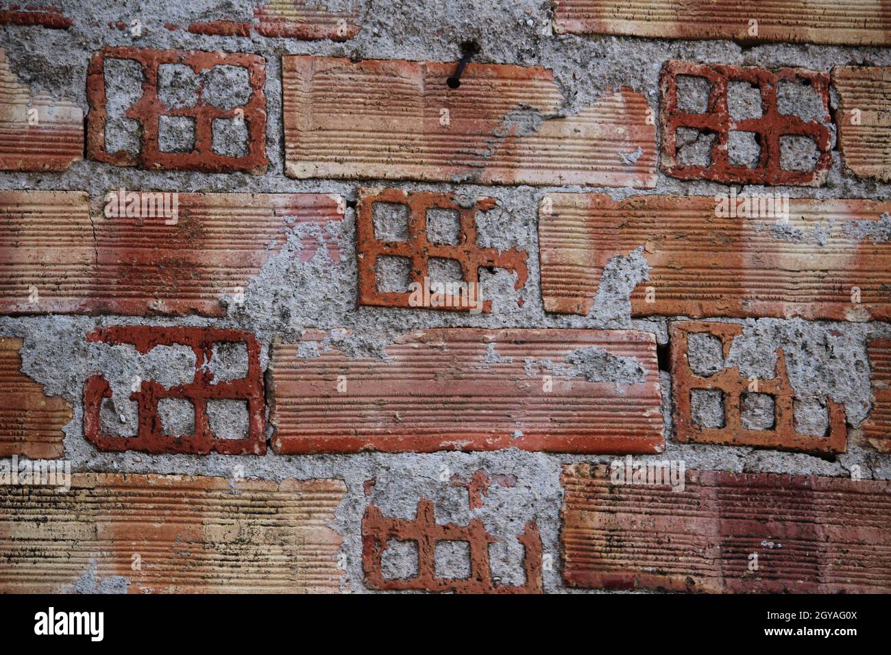 Close up shot of a brick wall with cement of an old and low quality ...