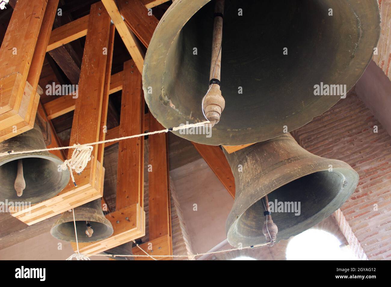 Close up shot of the mechanism work of four rusty gray bells in the ...