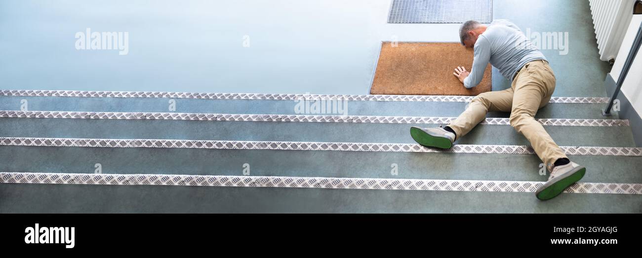 Mature Man Lying On Staircase After Slip And Fall Accident Stock Photo ...