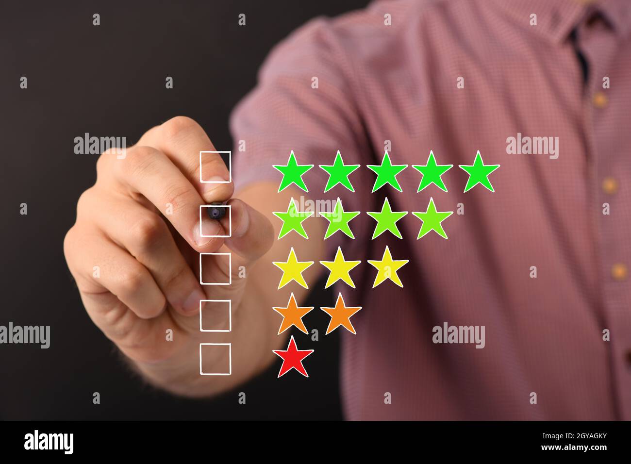 Man hand putting check mark a checkbox on five star rating on black ...