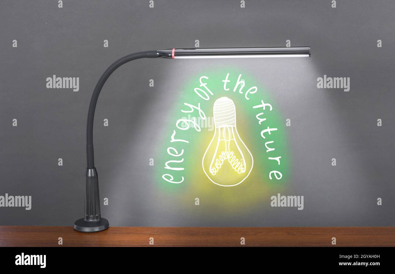 Flexible modern table LED Light shines on a drawn green incandescent ...