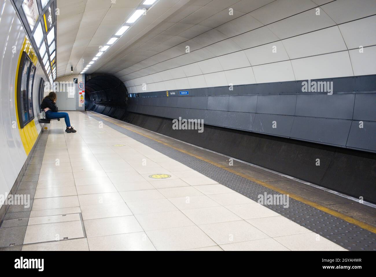 A lone young woman waiting for a Metro train at Moorfields in ...