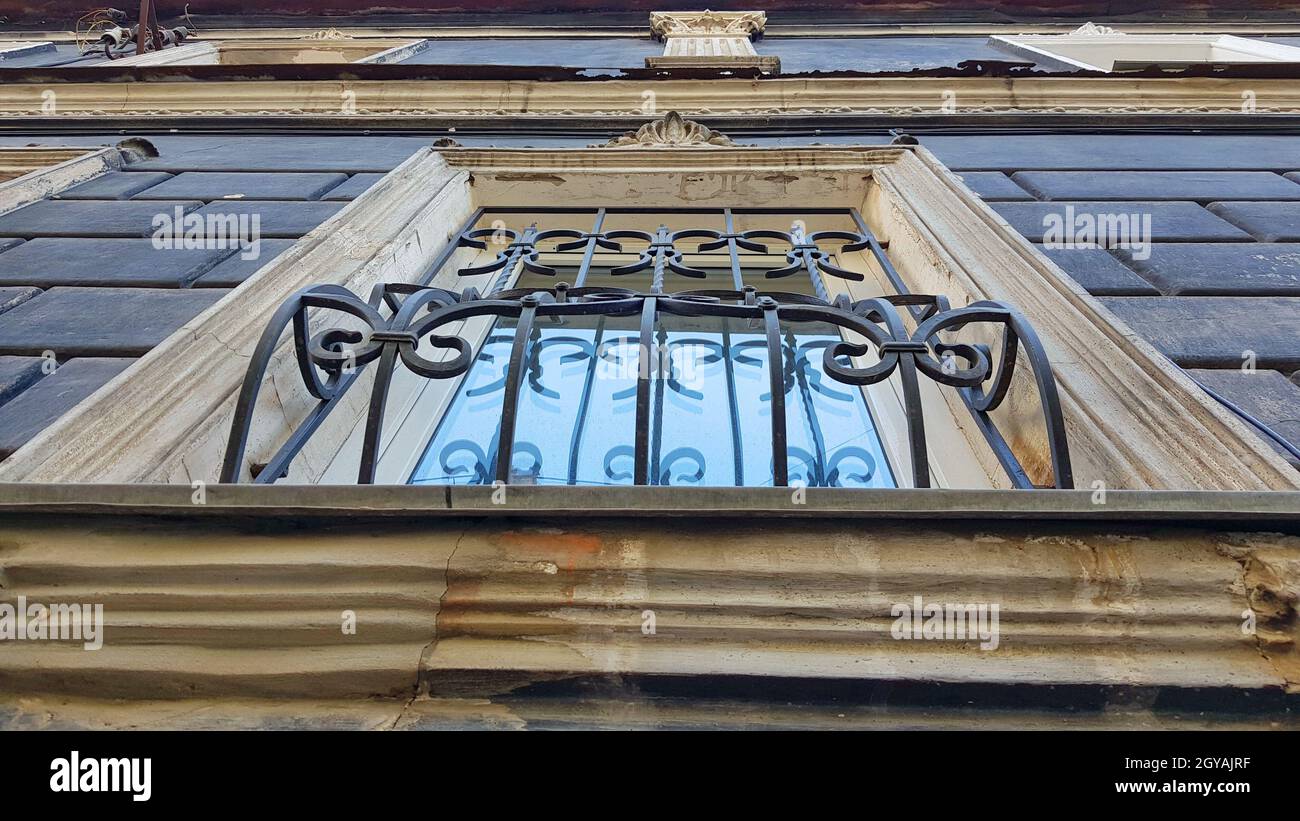 A window and pilaster of a beautiful old building in the historic part ...