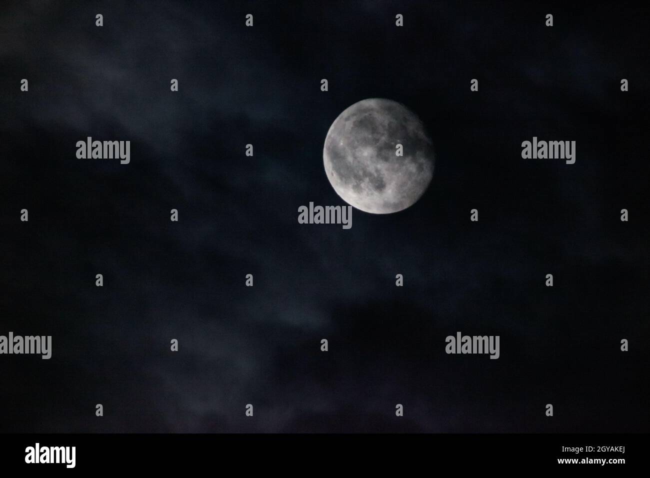 Full moon with an ominous dark sky and spooky wispy clouds Stock Photo ...