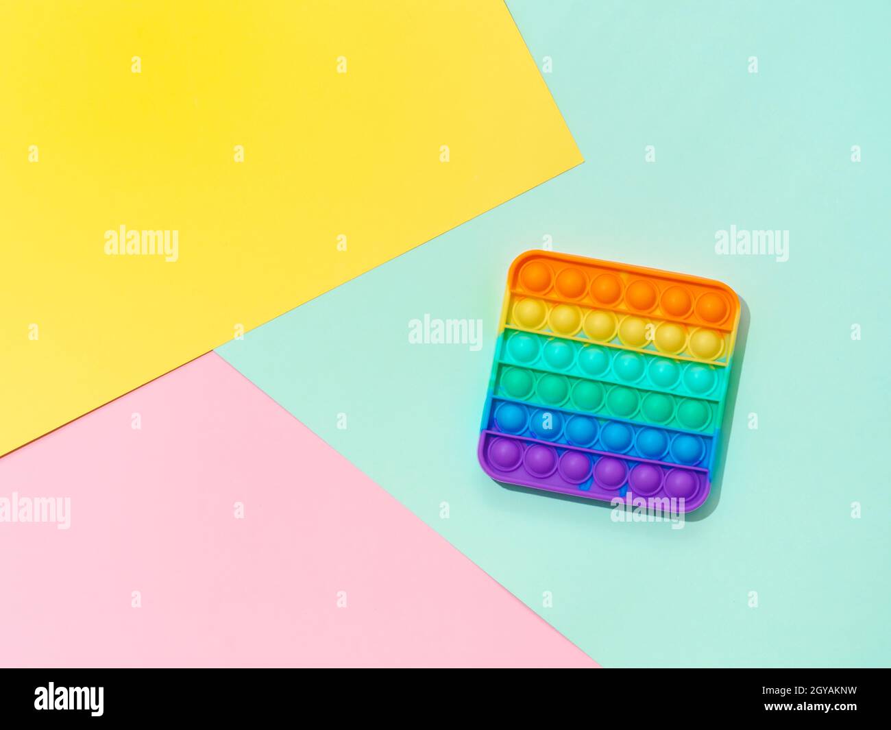 Popit or simple dimple toy on multicolor background. Popular silicone ...