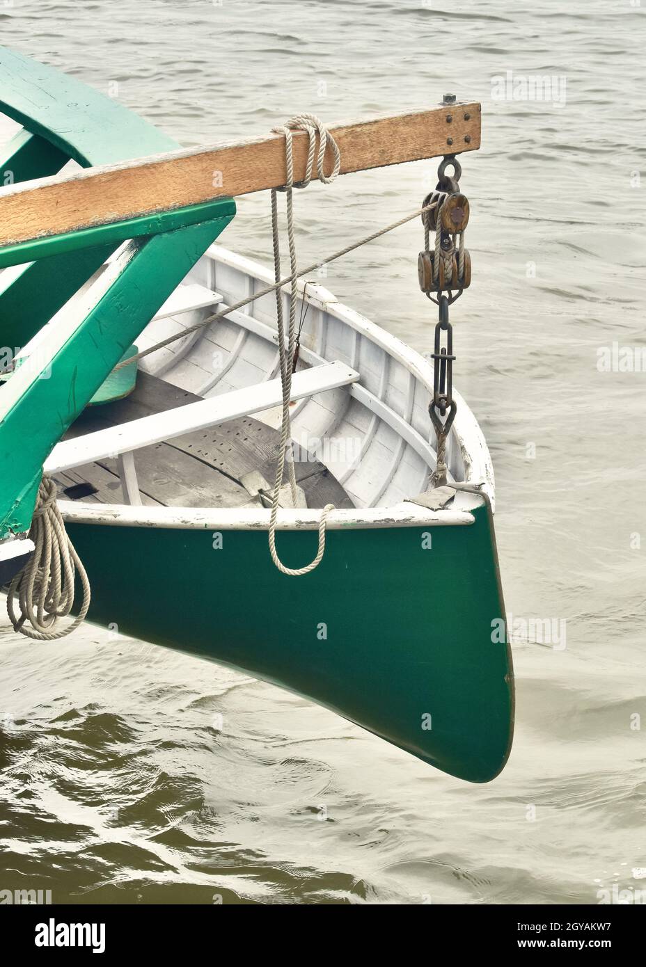 Old wooden lifeboat hoisted on the side of a tall sailing ship Stock ...