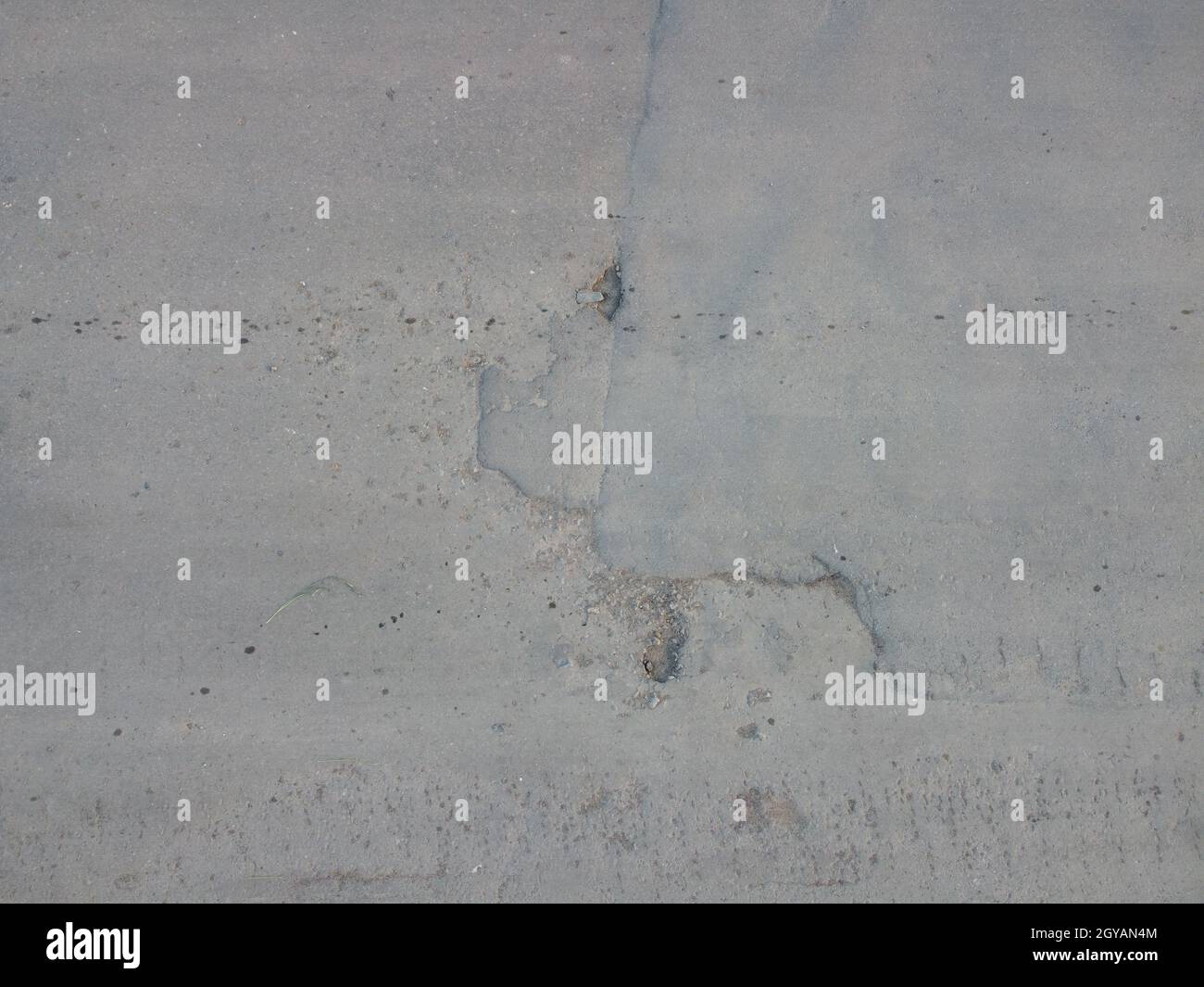 Potholes on the asphalt. Background of a broken road with potholes and ...