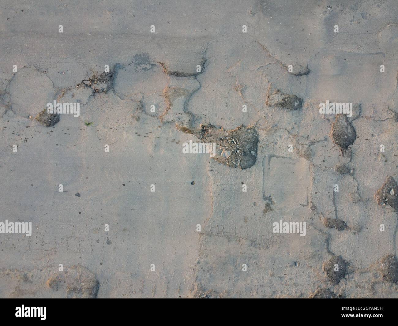 Deep pits on the asphalt, damaged road with potholes Stock Photo - Alamy