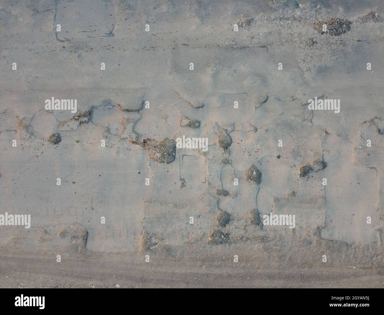 Poor condition of the road surface. Pits and potholes with cracks in ...