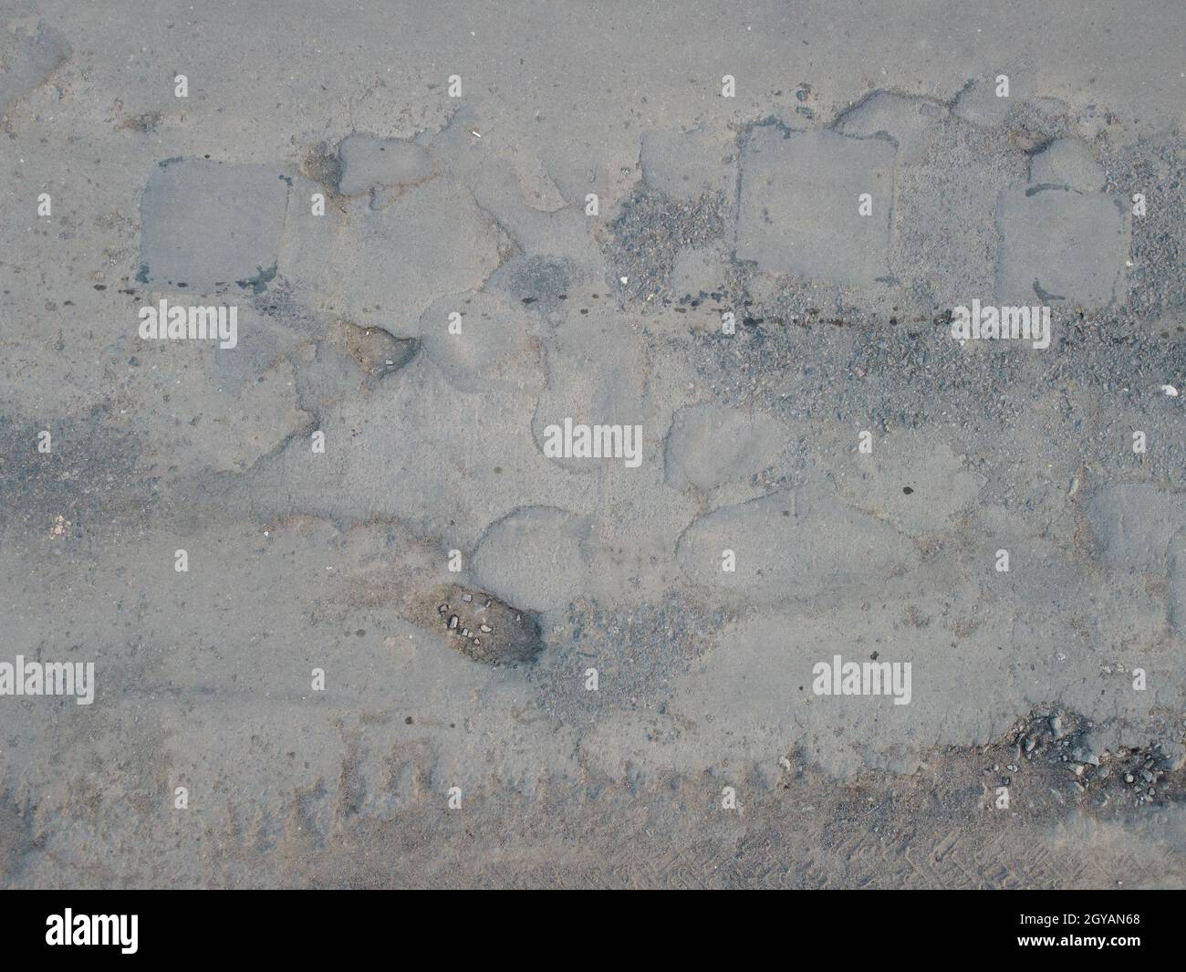 Potholes on the asphalt. Background of a broken road with potholes and ...