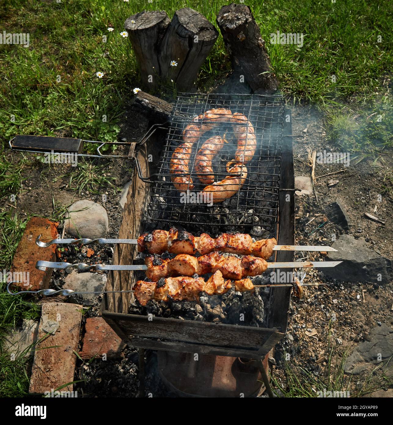 Man preparing shashlik or shish kebab over charcoal. Barbeque meat and ...