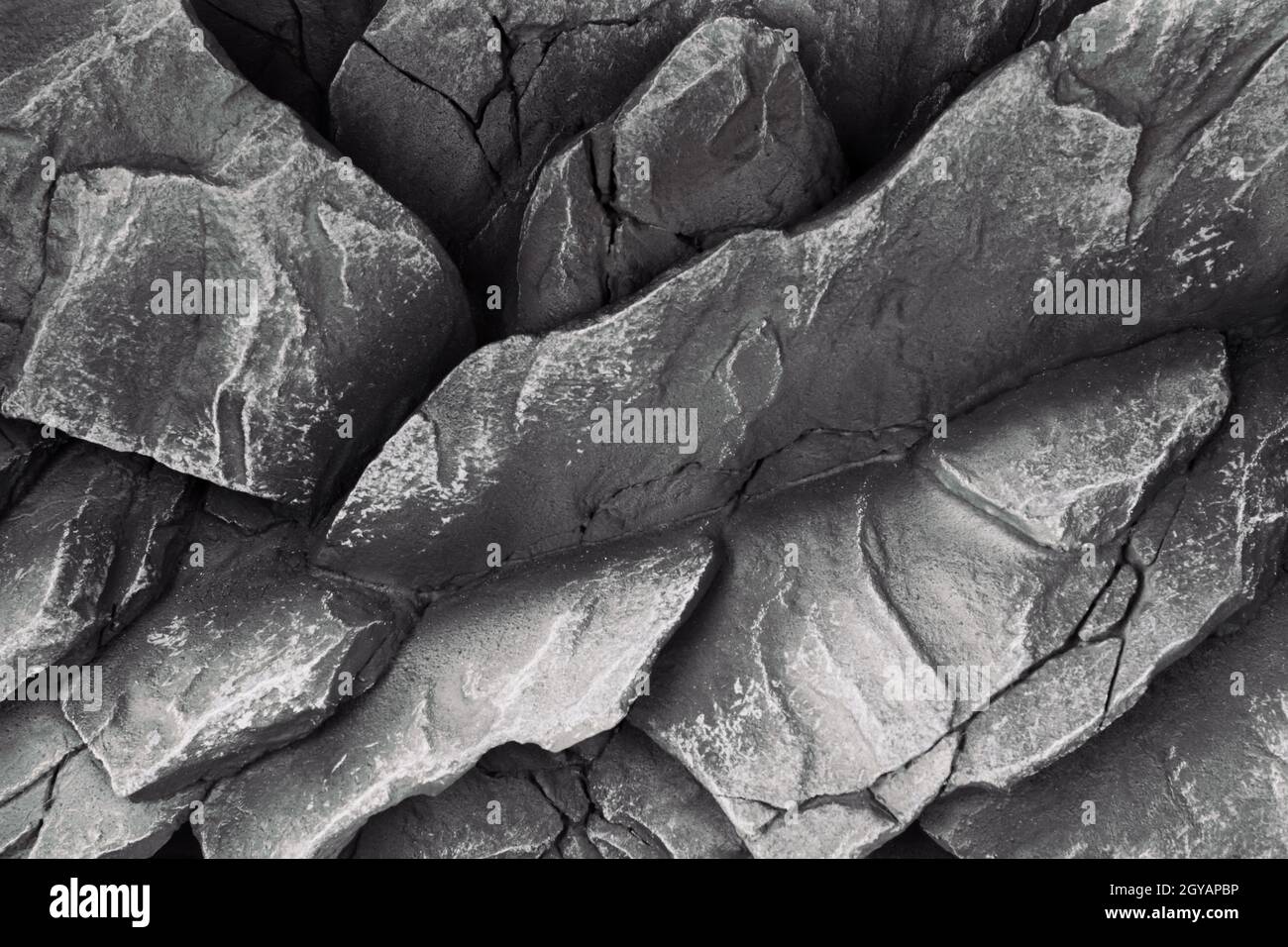 Embossed and rough grey stone or rock texture of mountains divided by ...