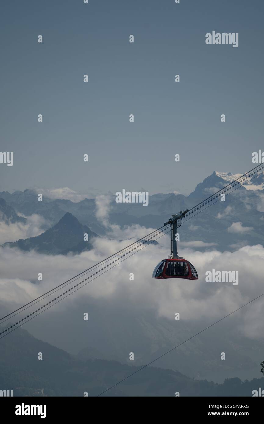 Vertical shot of cable cars in the clouds over the Mount Pilatus ...