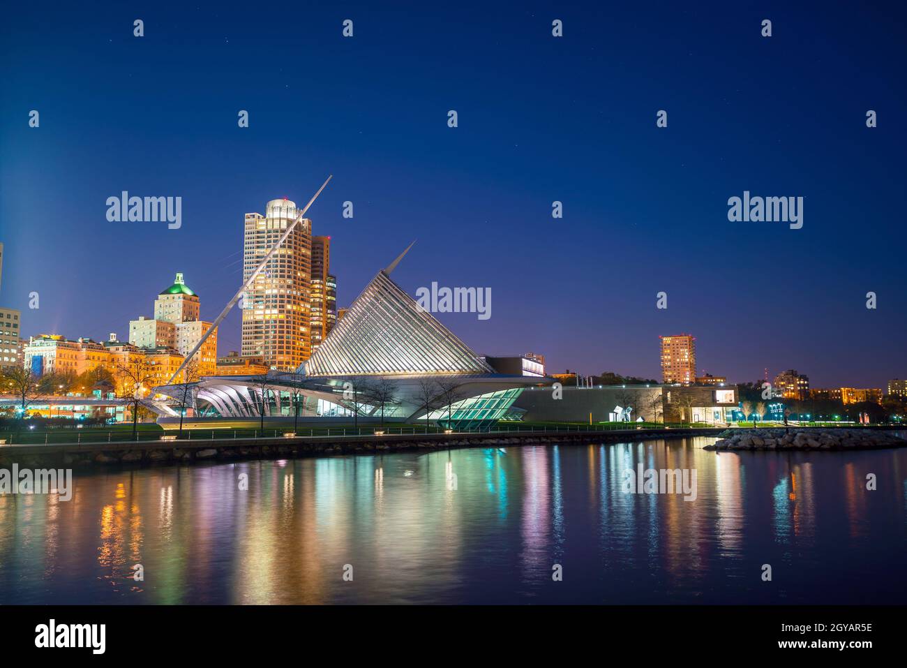 Milwaukee skyline at twilight with city reflection in lake Michigan and ...