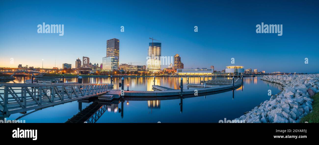 Milwaukee skyline at twilight with city reflection in lake Michigan and ...