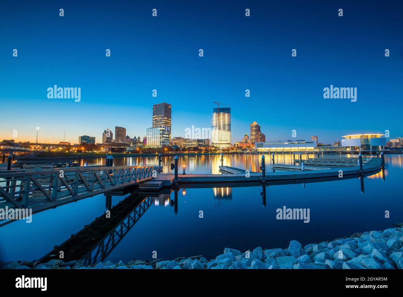 Milwaukee skyline at twilight with city reflection in lake Michigan and ...