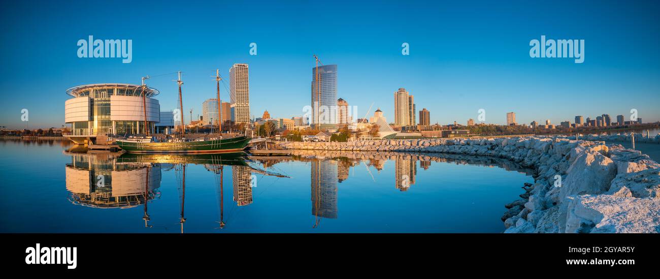 Milwaukee skyline at twilight with city reflection in lake Michigan and ...