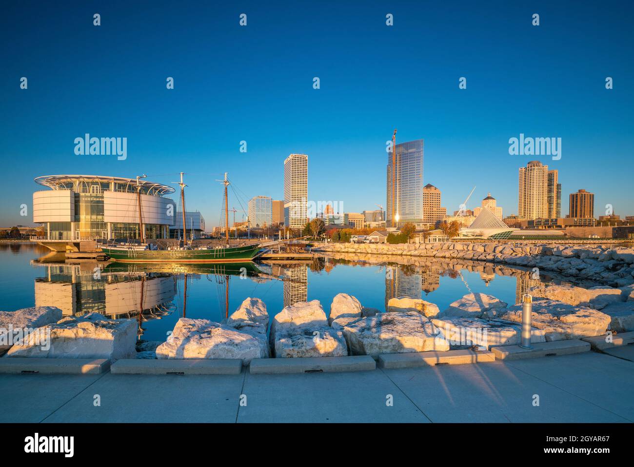 Milwaukee skyline at twilight with city reflection in lake Michigan and ...