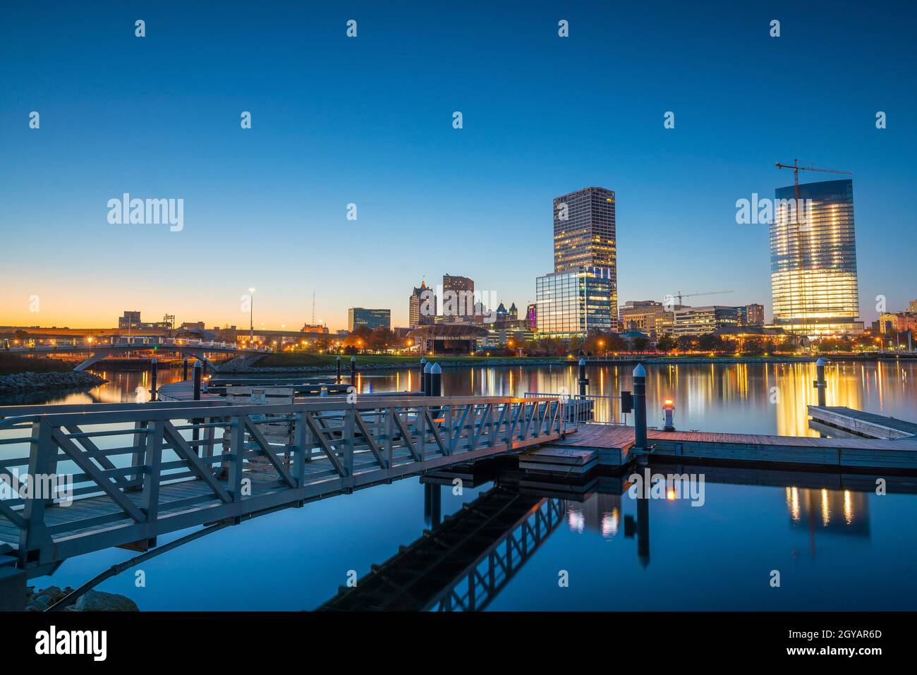 Milwaukee skyline at twilight with city reflection in lake Michigan and ...