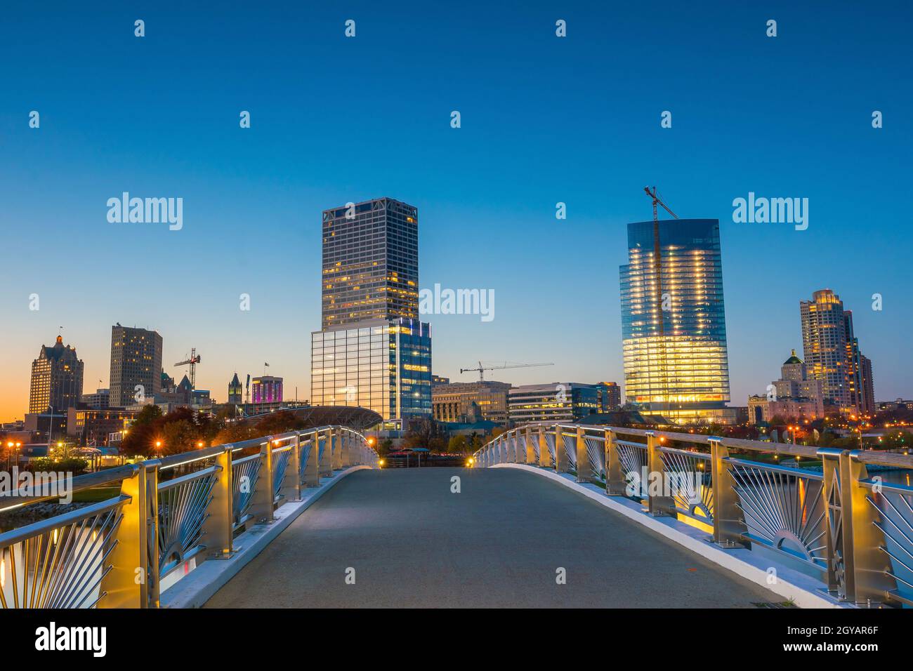 Milwaukee skyline at twilight with city reflection in lake Michigan and ...