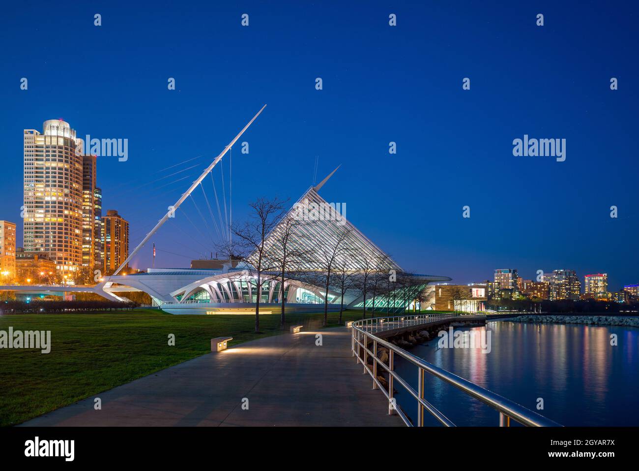 Milwaukee skyline at twilight with city reflection in lake Michigan and ...
