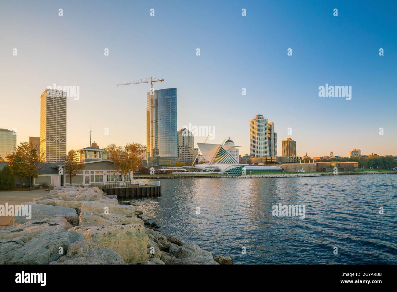 Milwaukee skyline at twilight with city reflection in lake Michigan and ...