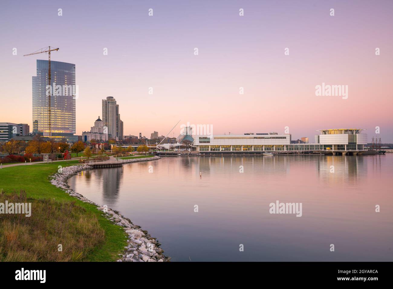 Milwaukee skyline at twilight with city reflection in lake Michigan and ...