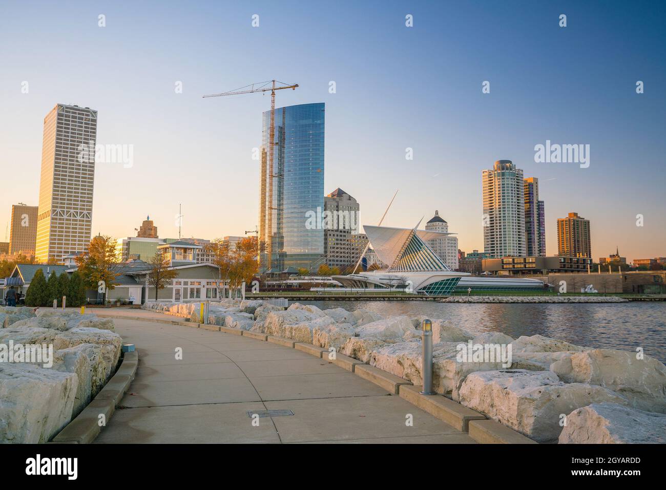 Milwaukee skyline at twilight with city reflection in lake Michigan and ...