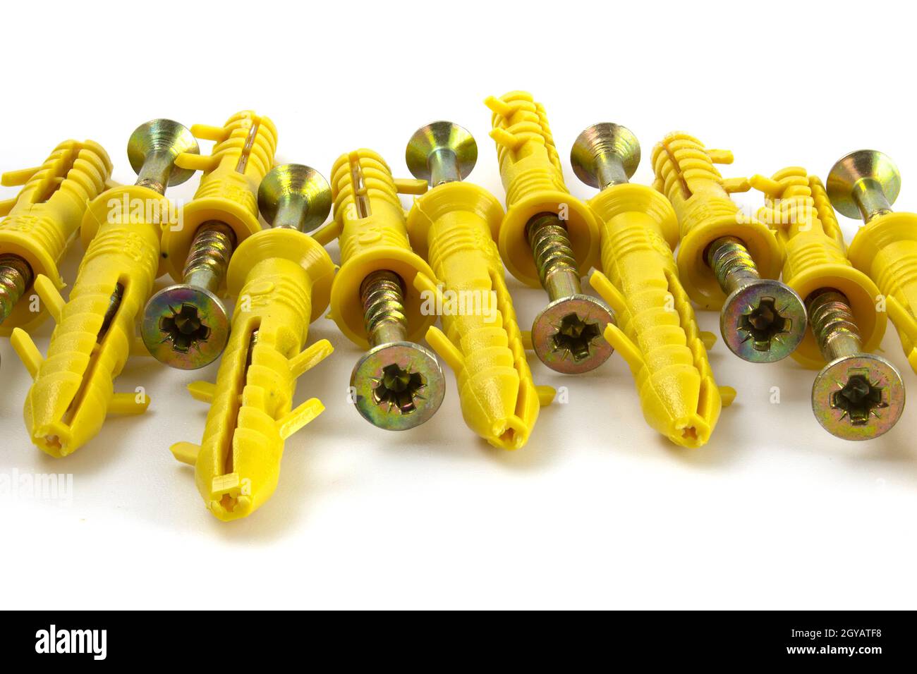 Screw anchor or dowel, yellow, isolated on white background Stock Photo ...