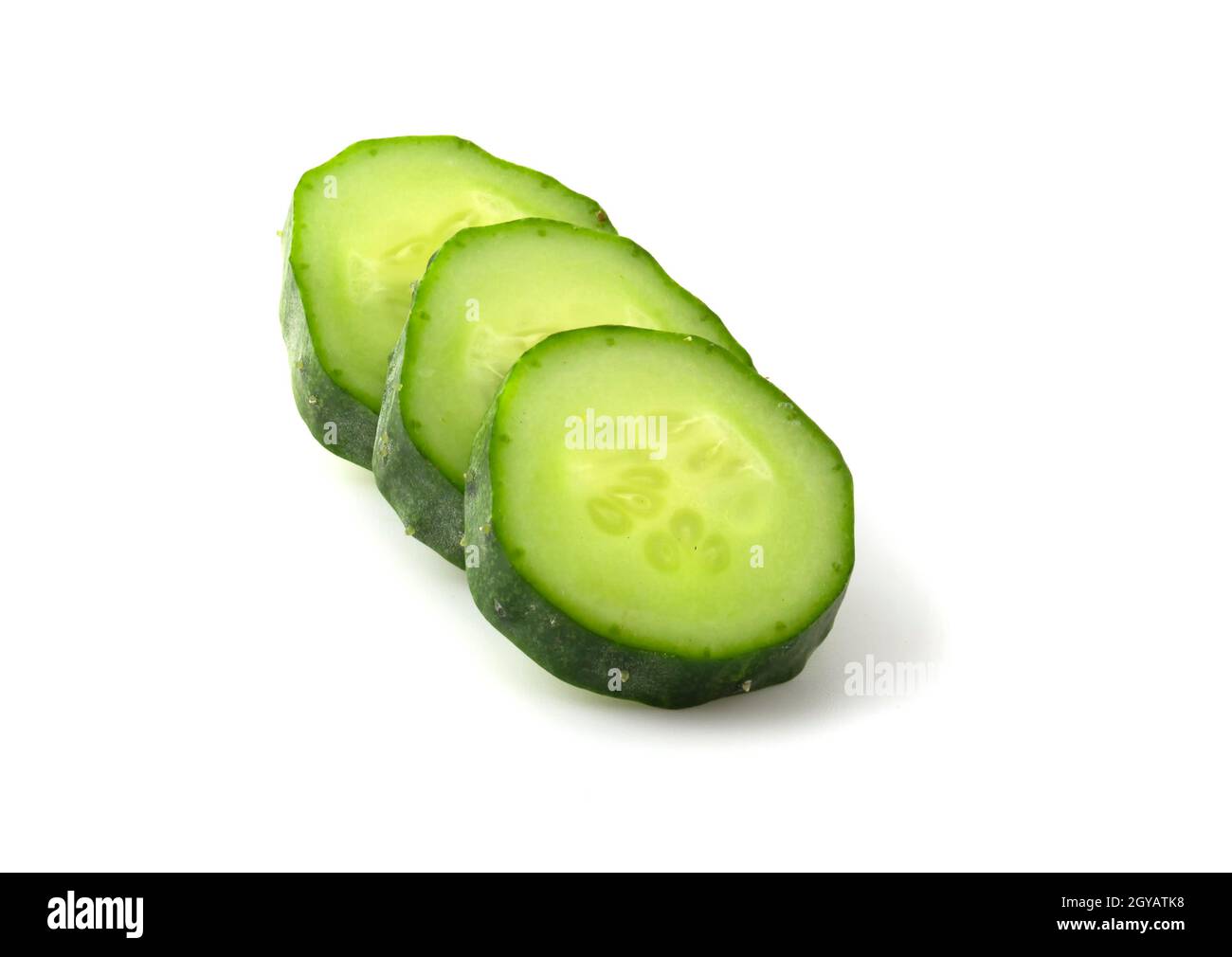 Fresh slices of cucumber sliced into ice cubes isolated on white ...