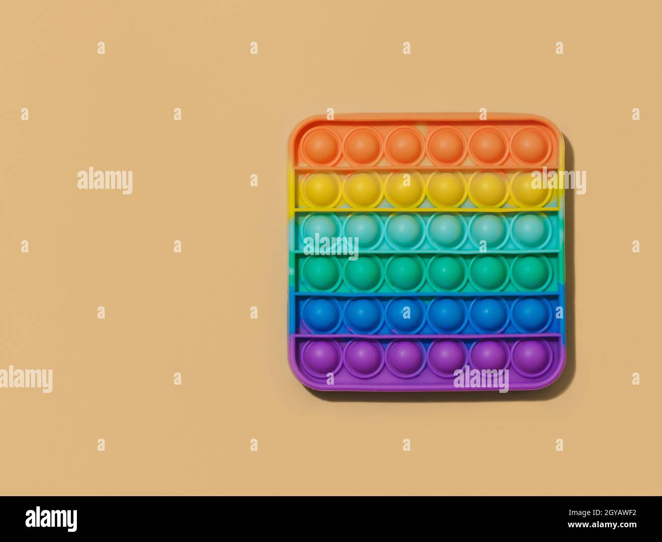 Popit on pastel beige background with copy space. Popular silicone ...