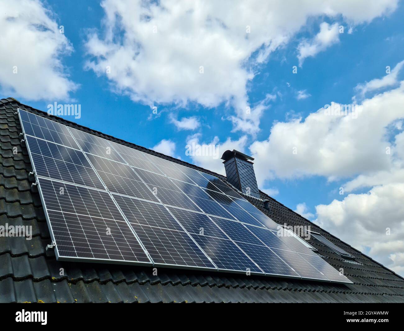 Solar panels producing clean energy on a roof of a residential house ...
