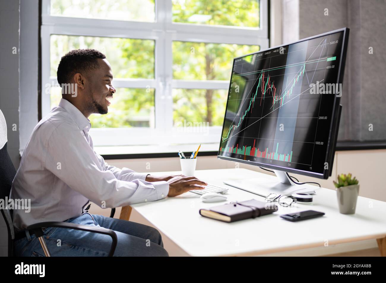 African American Man Trading Stock Market Online On Computer Stock ...
