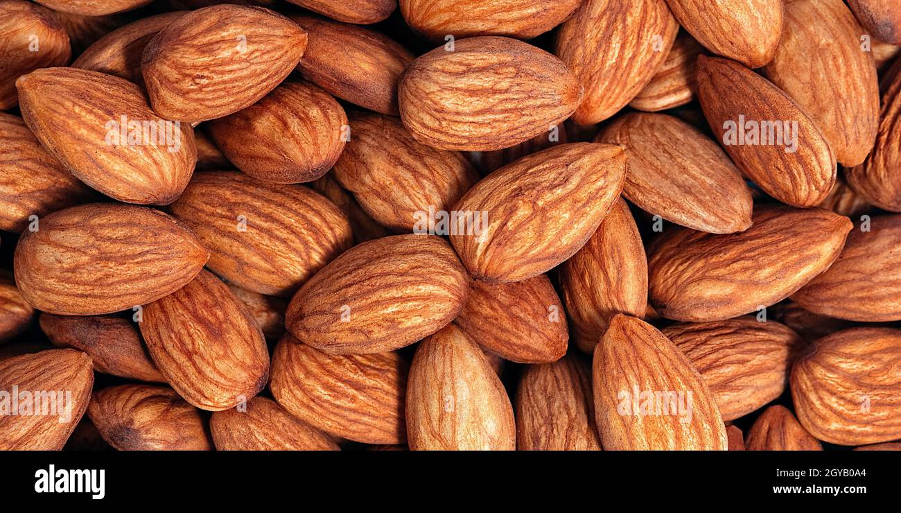 Background of almonds. Fried almonds. Scattered almond grains ...