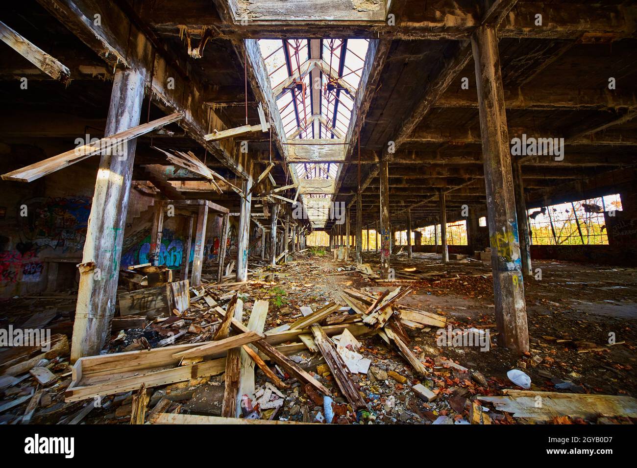 Abandoned and decayed building with caved in roof and broken support ...