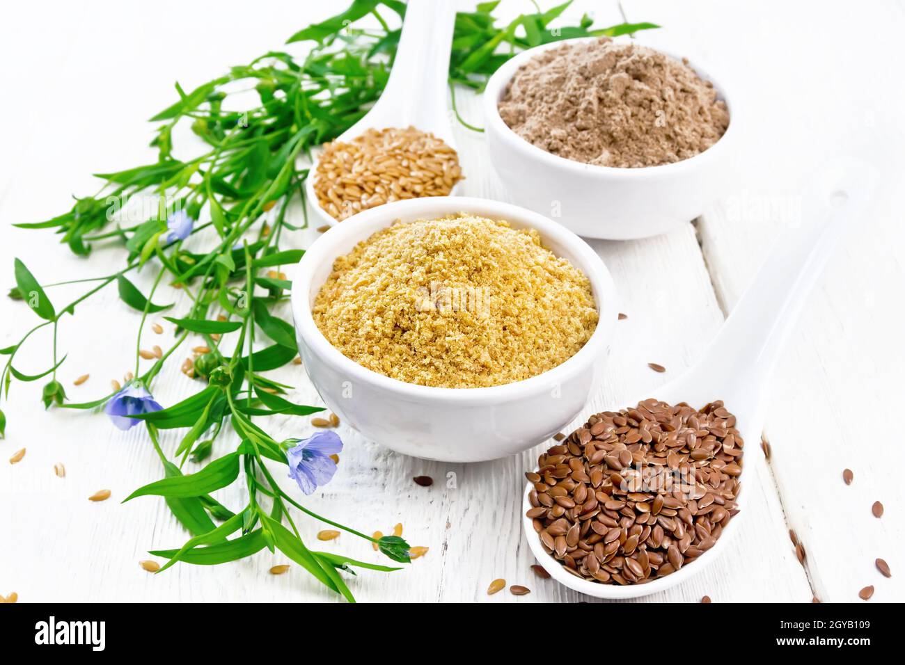 Linen bran and flour in two bowls, seeds in spoons, flax leaves and ...