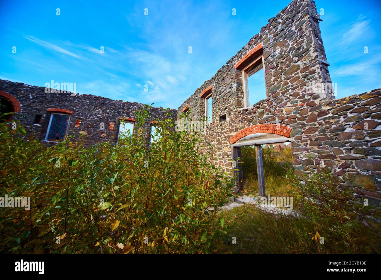 Interior of roofless abandoned building with sky fully visible and ...