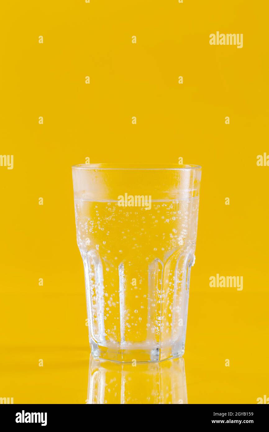 Glass of water on yellow background. Healthy lifestyle Stock Photo - Alamy