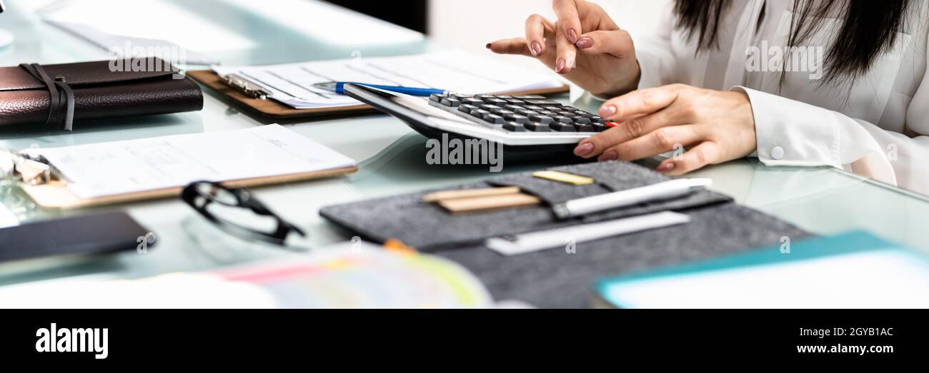 Accountant Doing Tax And Accounting Work Using Calculator Stock Photo ...