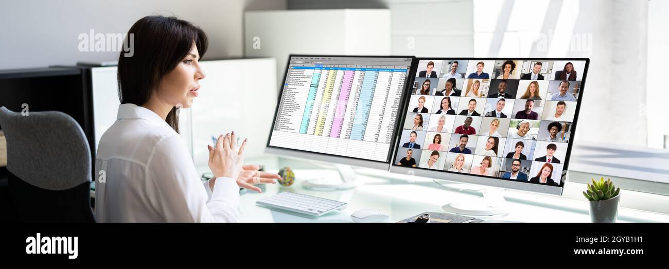 Virtual Video Conference On Multiple Monitor Screens In Office Stock ...