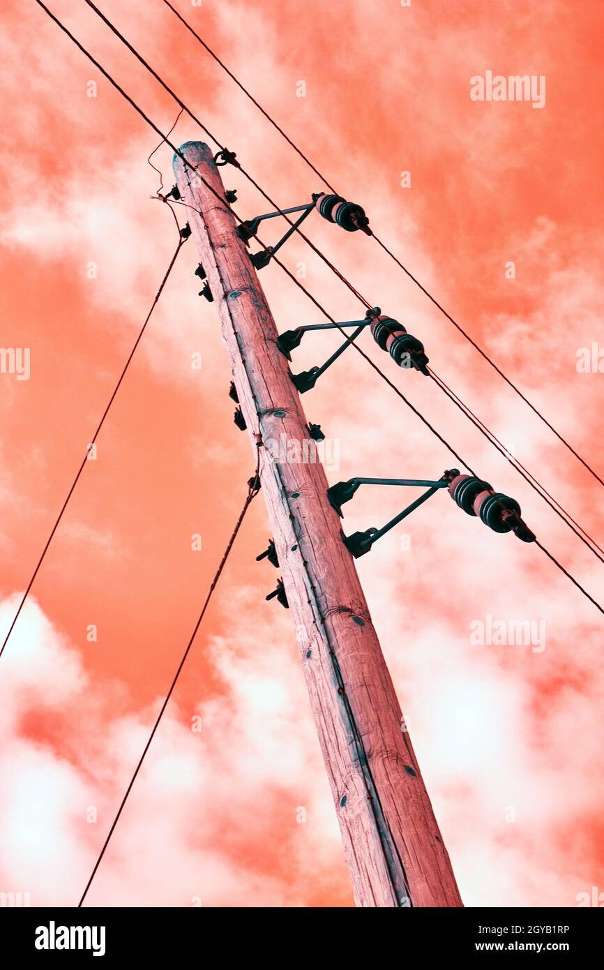 Infrared telephone pole with a red and orange tint Stock Photo - Alamy