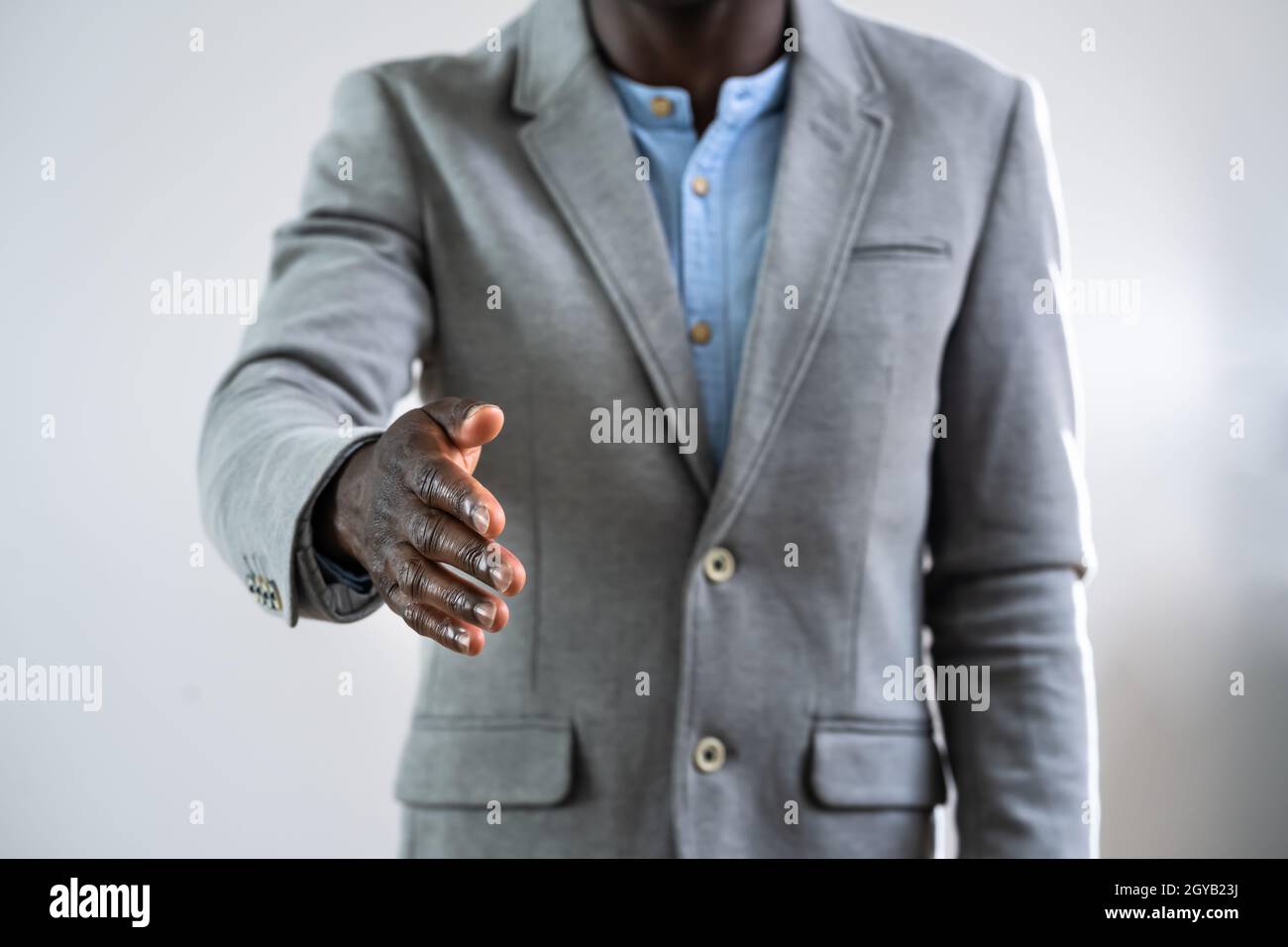 Young Shaking African Man. Welcoming Handshake Offer Stock Photo - Alamy
